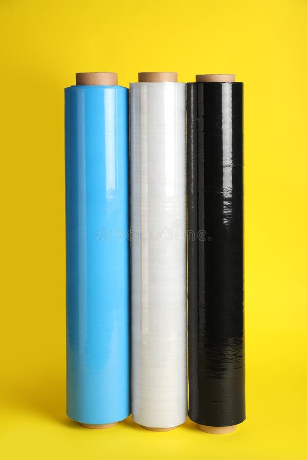 Rolls of Different Stretch Wrap on Yellow Background Stock Photo ...
