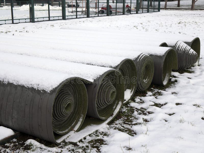 Rolls of Fake Grass Covered with Snow are Waiting upon Time. Artificial ...