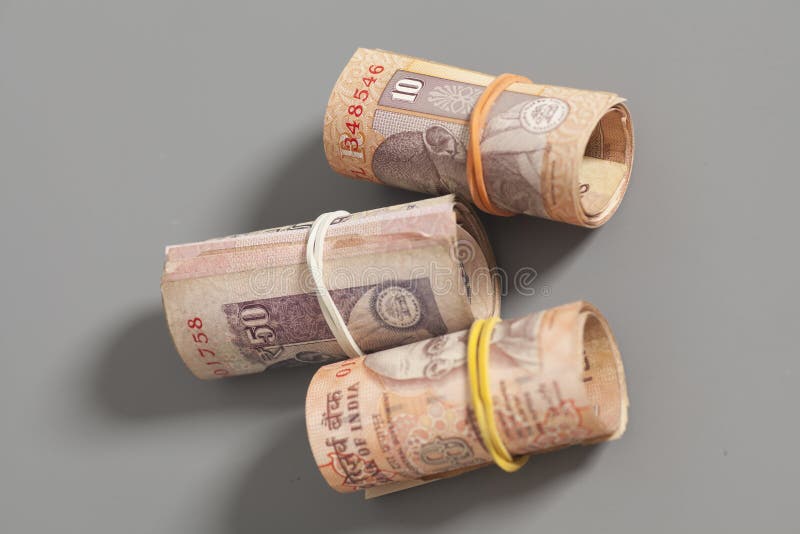 Rolls of Indian 10 Rupee Currency Notes and One Open 10 Rupee Note on ...