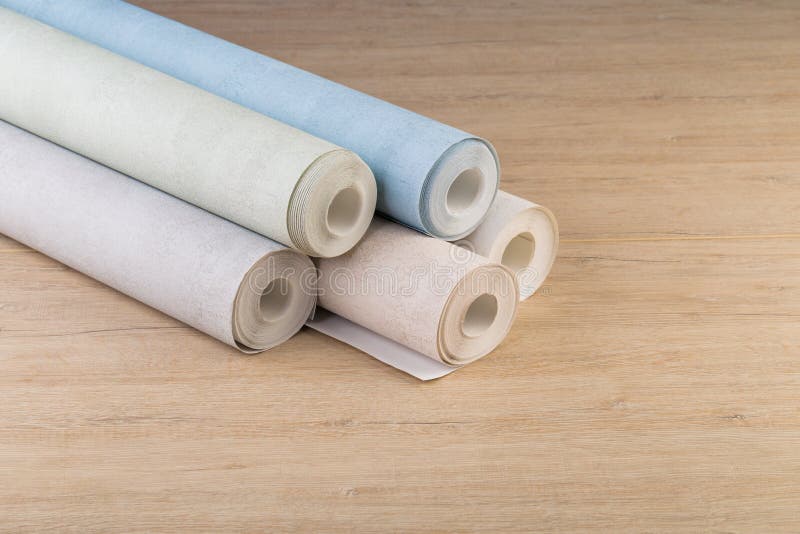 Rolls of Multi-colored Paper Wallpaper on a Wooden Table Stock Photo ...