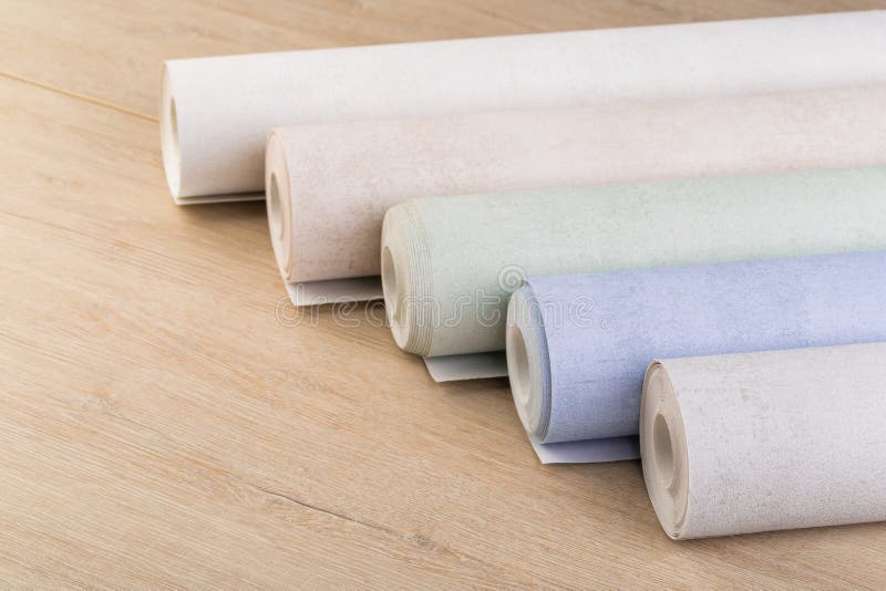 Rolls of Multi-colored Paper Wallpaper on a Wooden Table Stock Photo ...