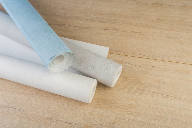 Rolls of Multi-colored Paper Wallpaper on a Wooden Table Stock Image ...