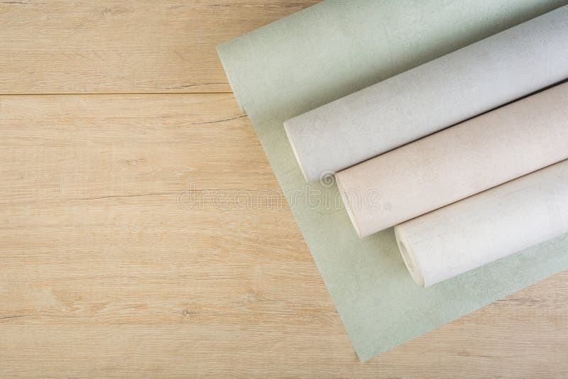 Rolls of Multi-colored Paper Wallpaper on a Wooden Table Stock Photo ...