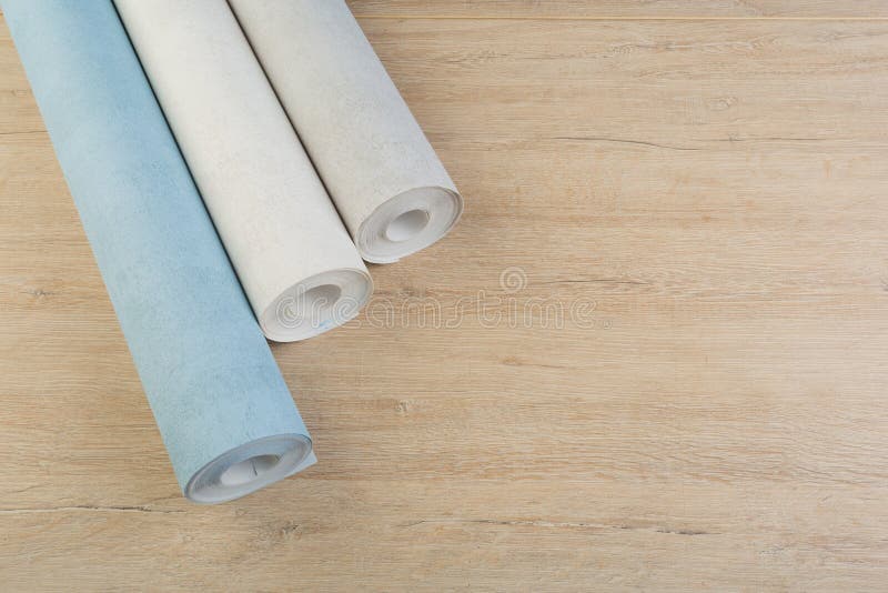 Rolls of Multi-colored Paper Wallpaper on a Wooden Table Stock Image ...