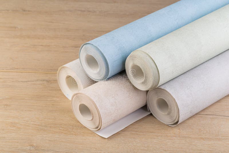 Rolls of Multi-colored Paper Wallpaper on a Wooden Table Stock Image ...