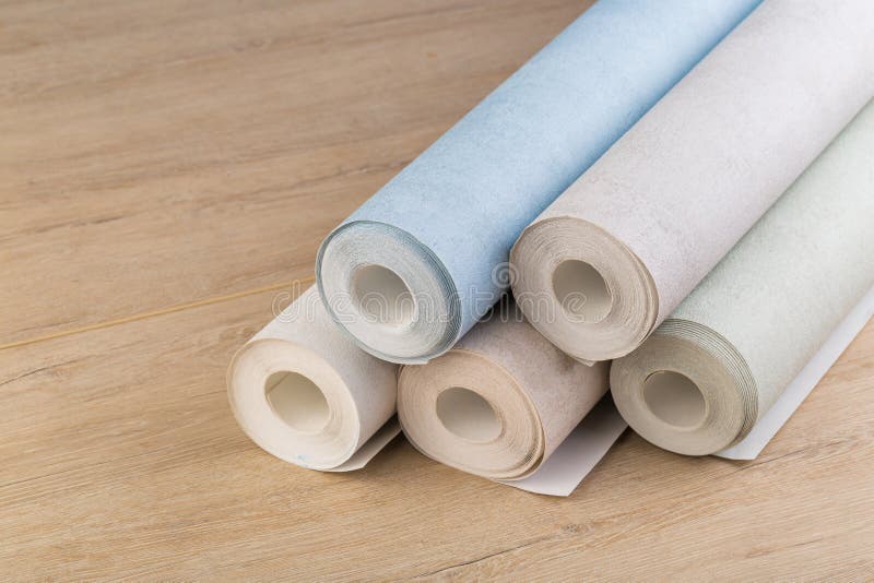 Rolls of Multi-colored Paper Wallpaper on a Wooden Table Stock Photo ...