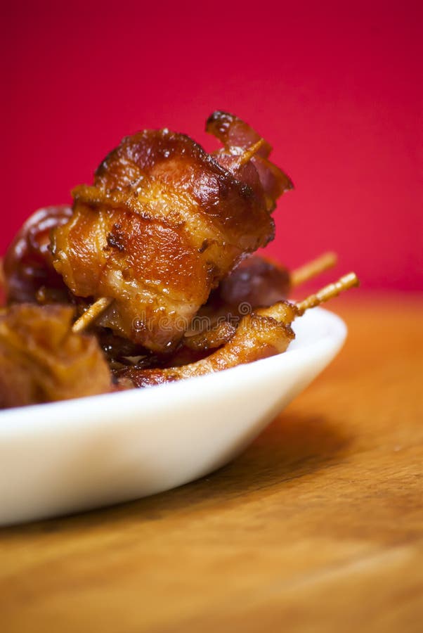 Rolls of Slices of Cooked Bacon Subject with a Toothpick on a Wh Stock ...