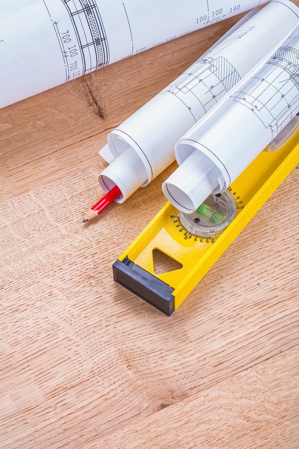 Rolls of White Blueprints and Level Pencil on Stock Photo - Image of ...