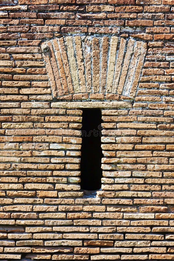 Roman brick wall with slit stock image. Image of walls - 75433593