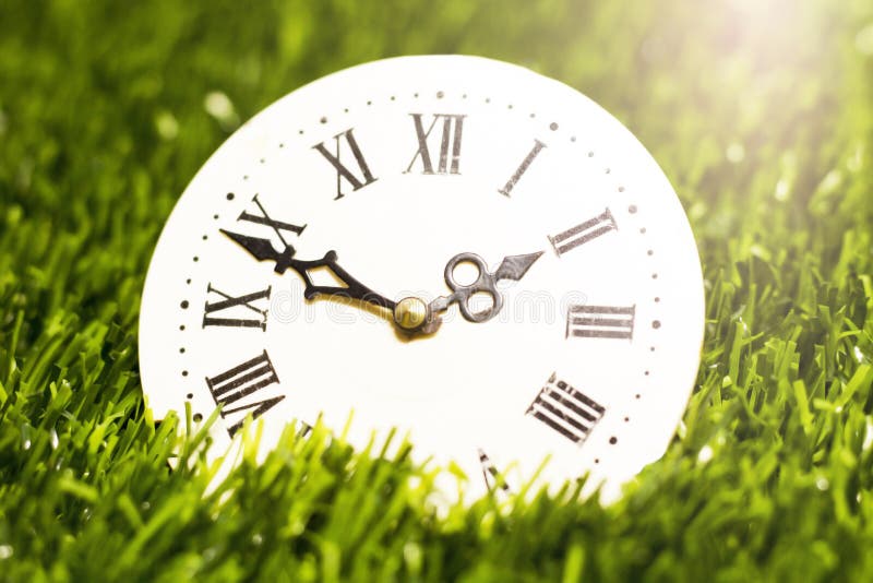 Roman Clock in the Green Grass, Summer. Stock Image - Image of grass ...