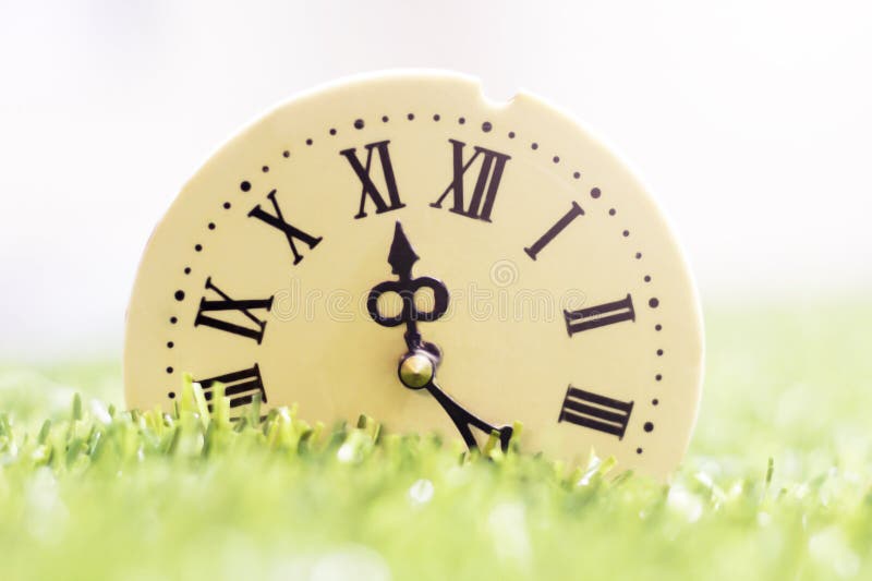 Roman Clock in the Green Grass, Summer. Stock Photo - Image of retro ...