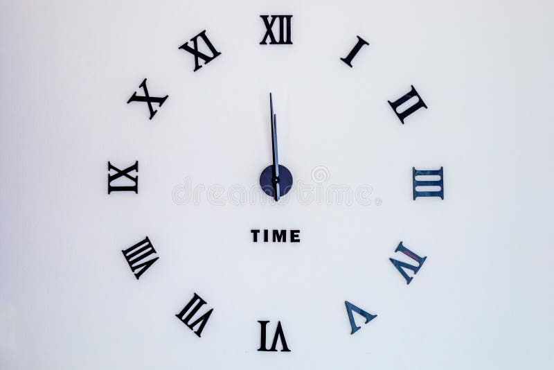 Roman Clock on the White Wall Background. Stock Image - Image of ...