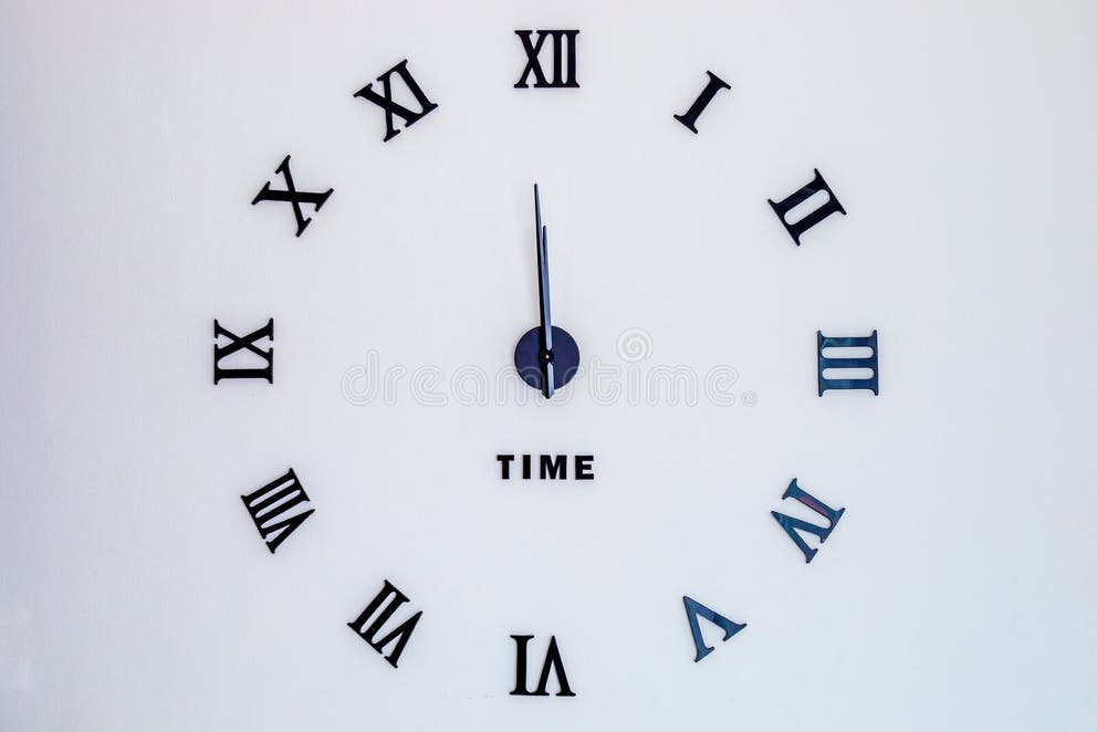 Roman Clock on the White Wall Background. Stock Image - Image of ...