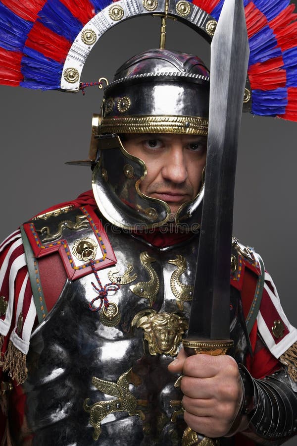 Roman Legionnaire Posing with Sword Isolated on Gray Stock Photo ...