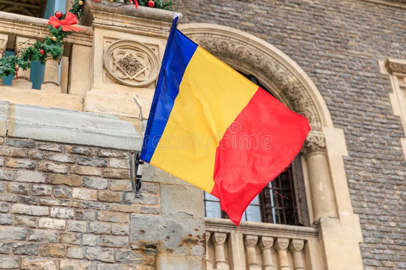 Romanian Flag Waving on Historic Stone Building with Architectural ...
