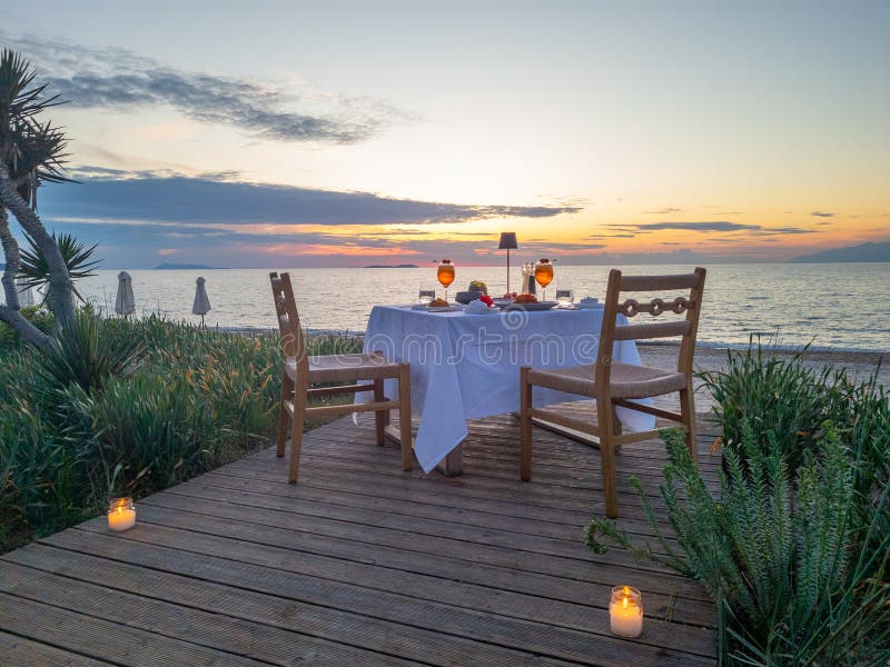 Romantic Beachside Dinner at Sunset. Enjoy the Ocean View Stock Image ...