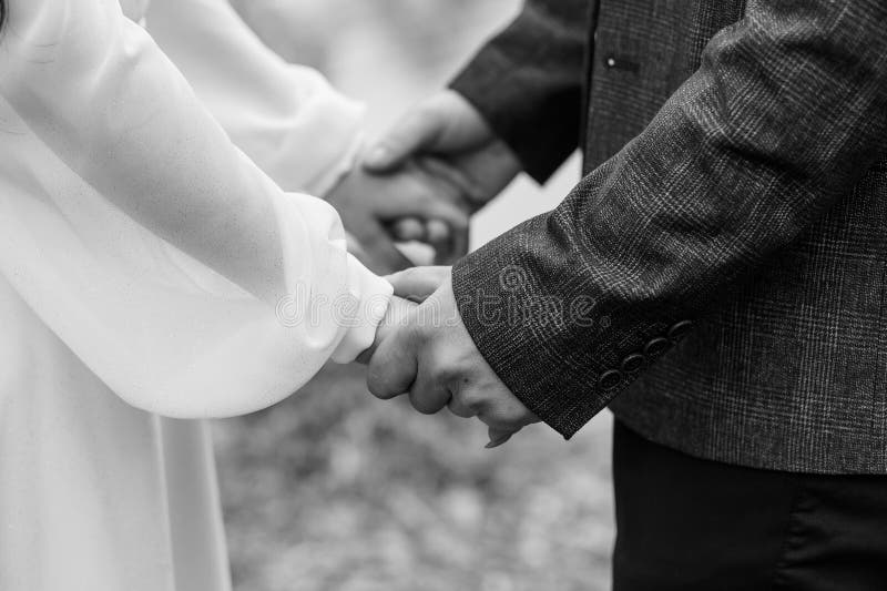 Romantic Black and White Close-up of a Couple Holding Hands in Nature ...