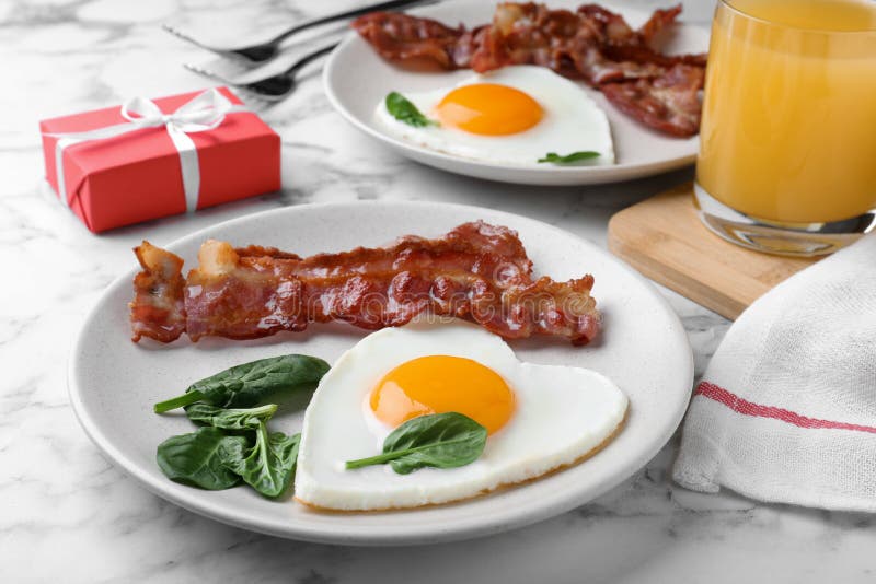 Romantic Breakfast with Fried Bacon and Heart Shaped Egg on White ...