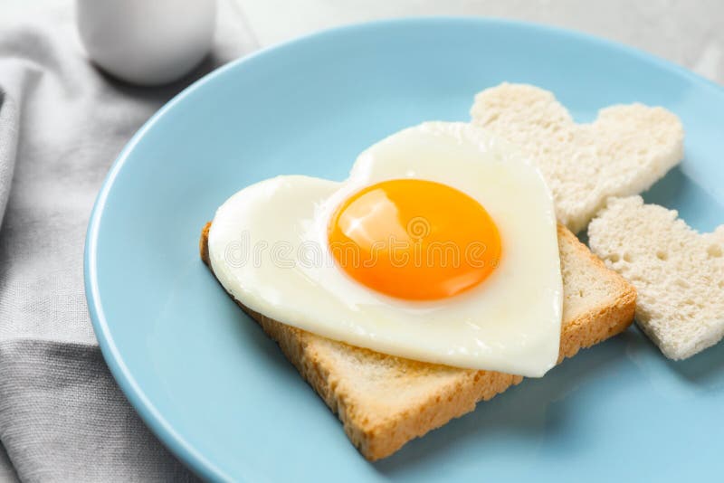 Romantic Breakfast with Heart Shaped Fried Egg and Toasts on Table ...