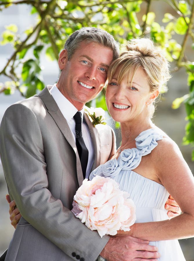 Senior Beach Wedding Ceremony with Cake in Foreground Stock Image ...