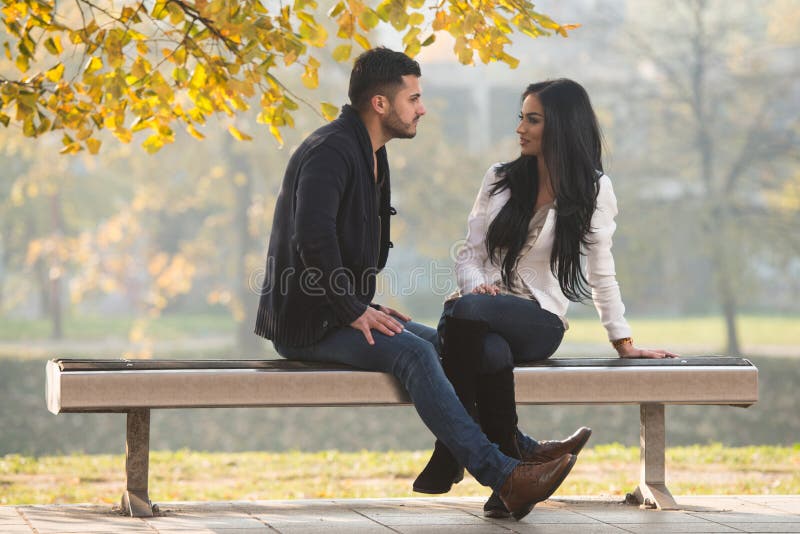 Romantic Couple on a Bench stock photo. Image of beauty - 65391388