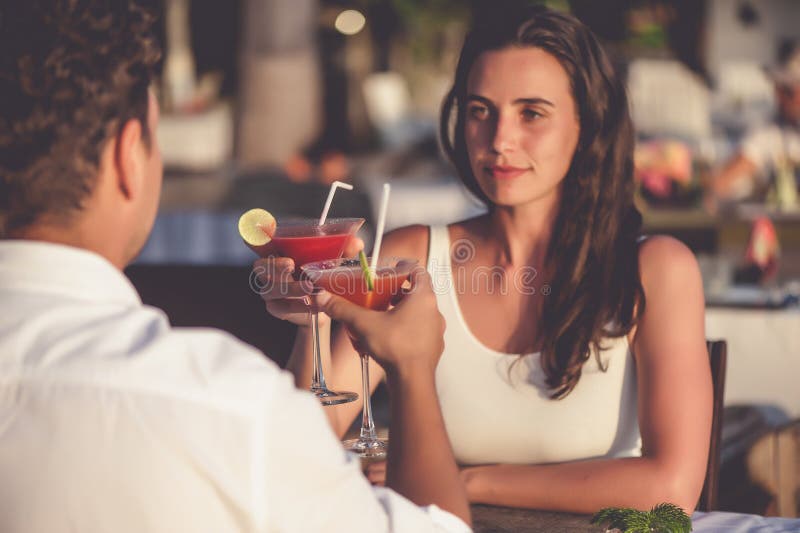 Romantic Couple Enjoy Sunset in Restaurant on the Beach Drinking ...