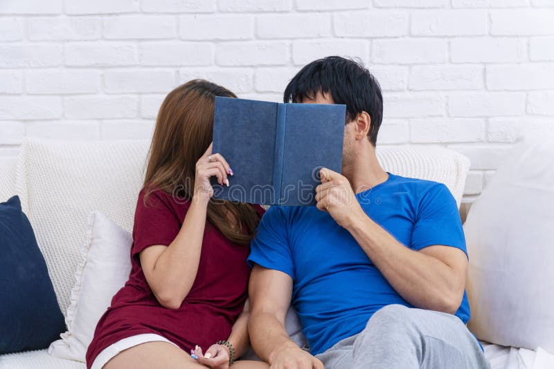 Romantic Couple Resting And Lying Down Face To Face Together On The Bed