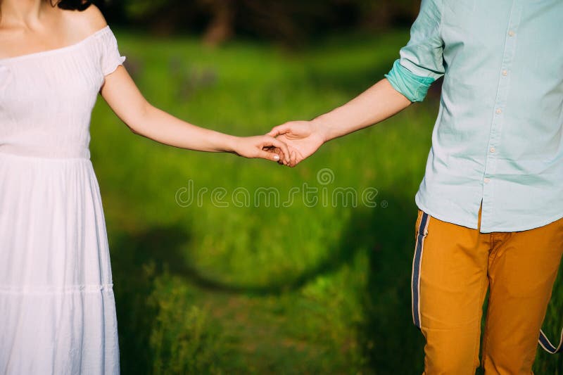 Romantic Couple Holding Hands Gently.shadow of Them on the Grass Stock ...