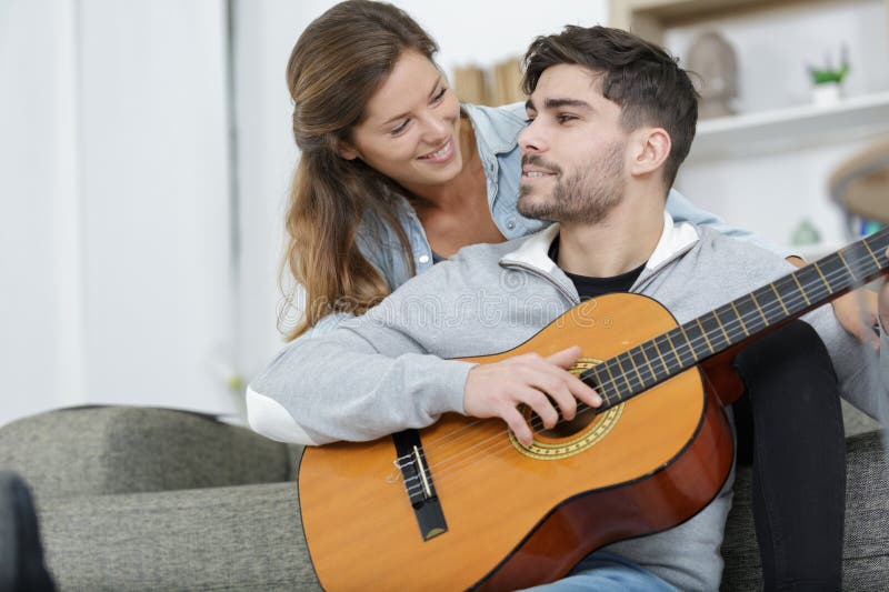 Romantic Couple at Home Man Plays Guitar Stock Image - Image of ...