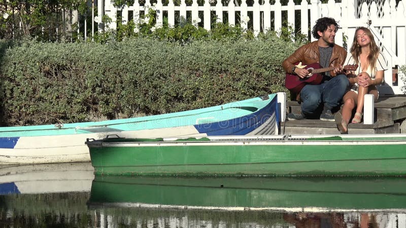 Romantic Couple Singing by Boats in a Canal Stock Footage - Video of ...