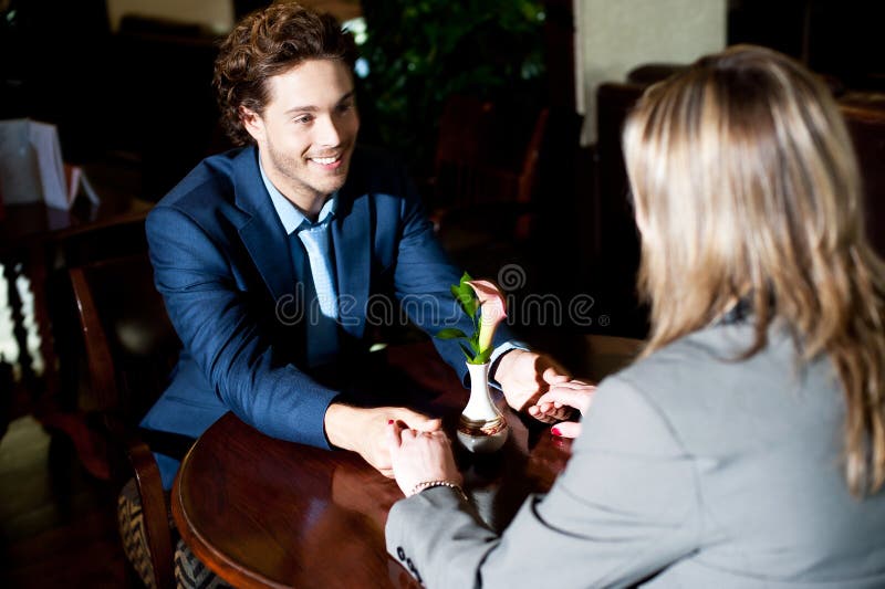 Romantic Couple Sitting Across the Table Stock Image - Image of chair ...
