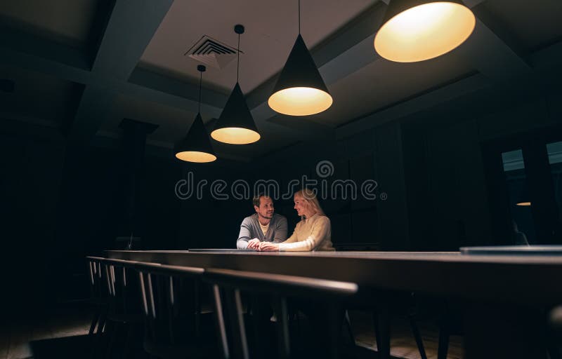 The Romantic Couple Sitting at the Table in Empty Night Restaurant ...