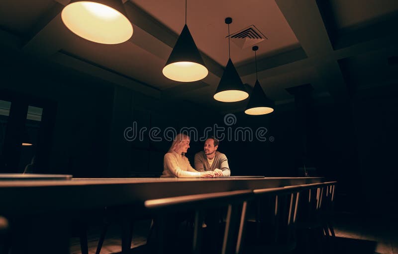 The Romantic Couple Sitting at the Table in Empty Night Restaurant ...