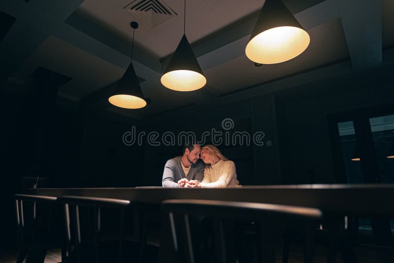 The Romantic Couple Sitting at the Table in Empty Night Restaurant ...