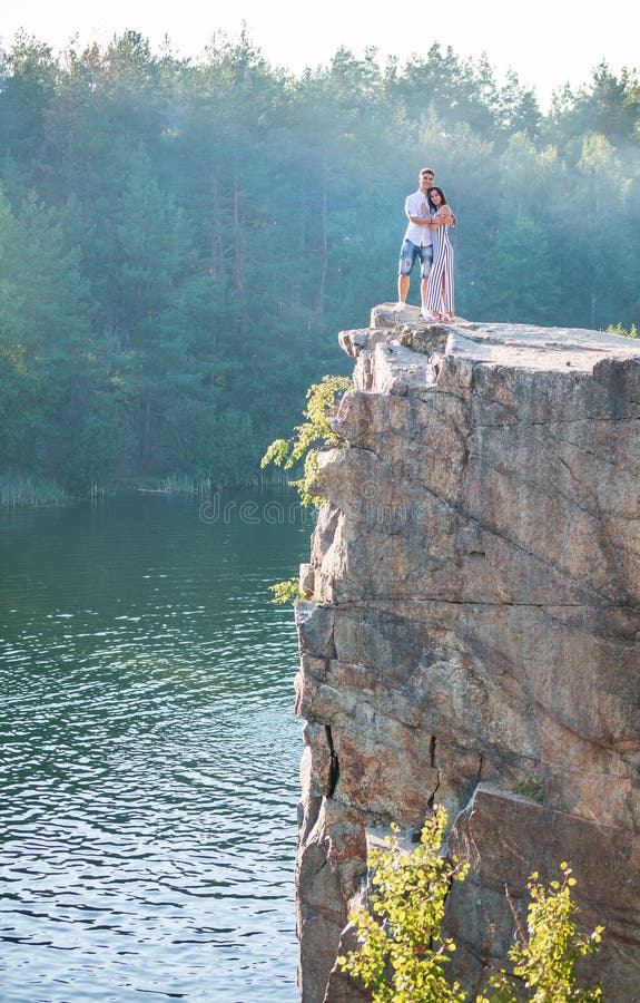 Romantic Couple Standing on Cliff Over River Stock Photo - Image of ...
