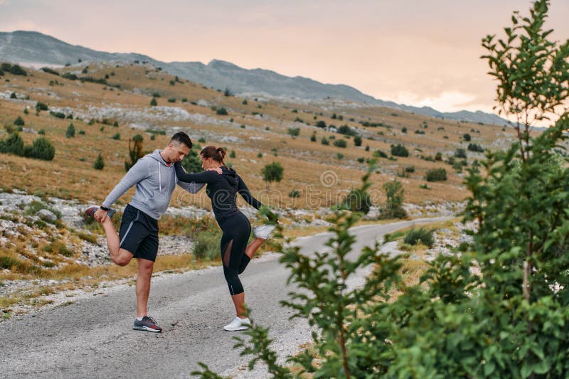 A Romantic Couple Stretching Down after a Run Stock Photo - Image of ...