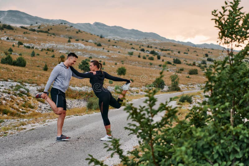 A Romantic Couple Stretching Down after a Run Stock Photo - Image of ...