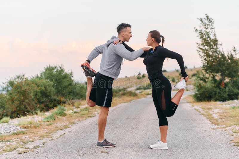 A Romantic Couple Stretching Down after a Run Stock Photo - Image of ...