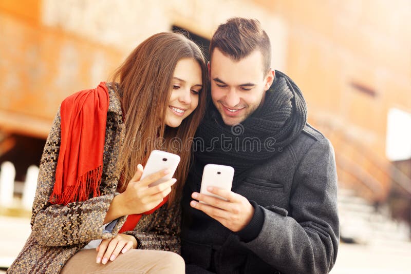 Romantic Couple Using Smart Phones during Autumn Walk Stock Image ...