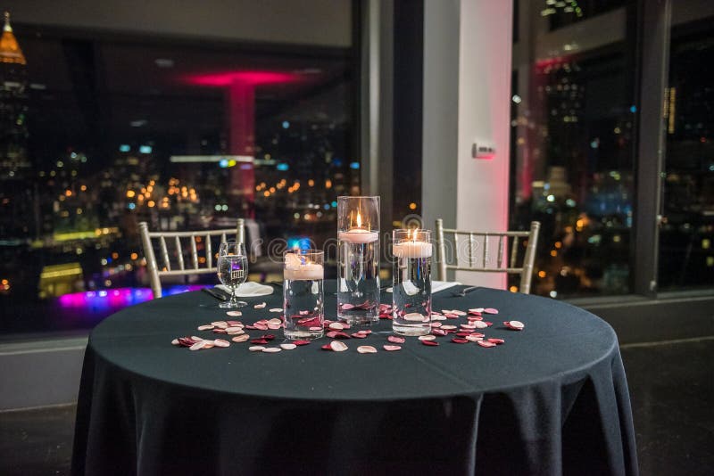 Romantic Date Table Decorated with Candles and Rose Petals with a ...