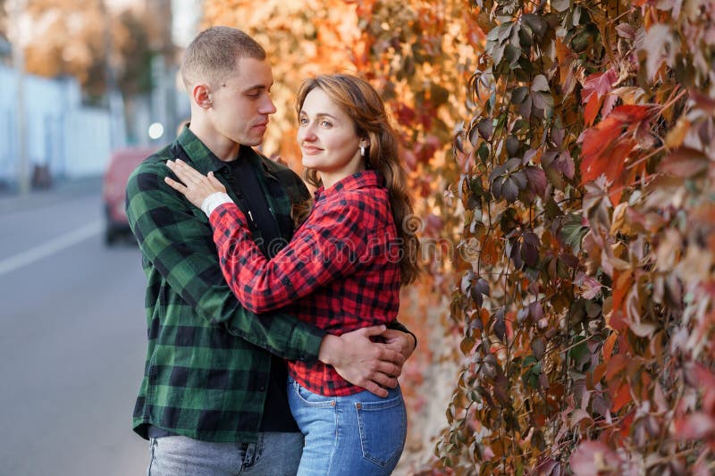 A Romantic Embrace of a Couple Surrounded by Autumn Leaves Stock Photo ...