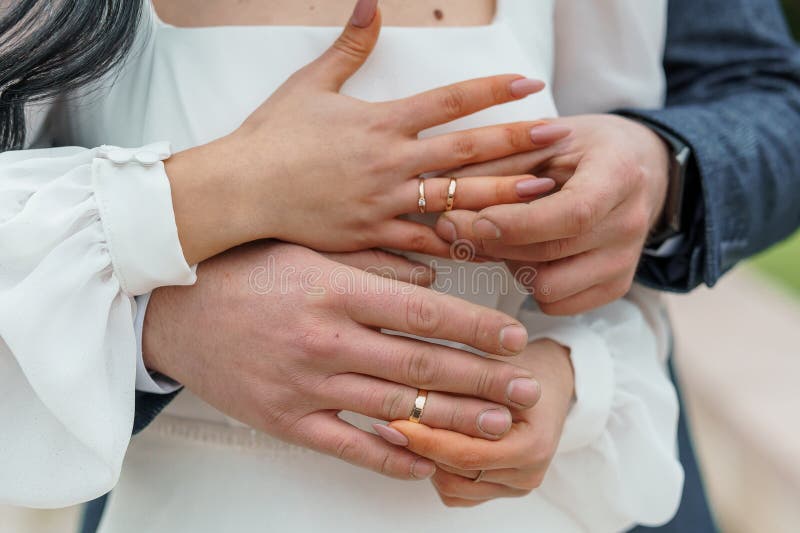 Romantic Engagement Moment with Intertwined Hands and Wedding Rings ...