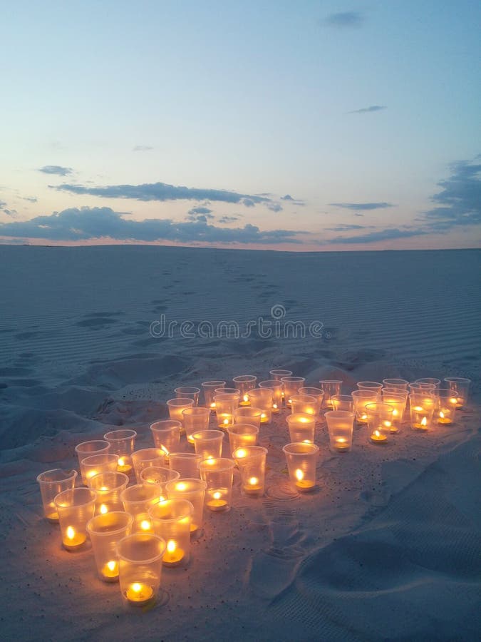 A Romantic Evening in a Deserted Place. Candles on the Sand in an ...