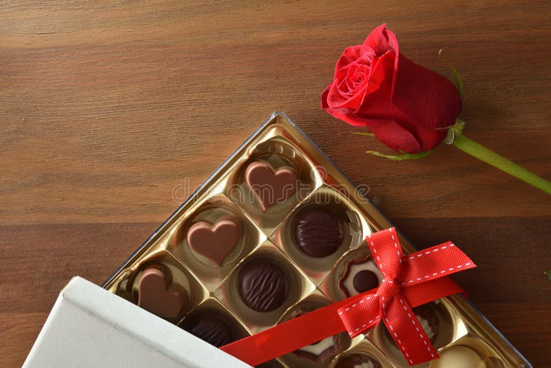 Romantic Gift with Chocolates with Bow and Rose on Wooden Stock Image ...