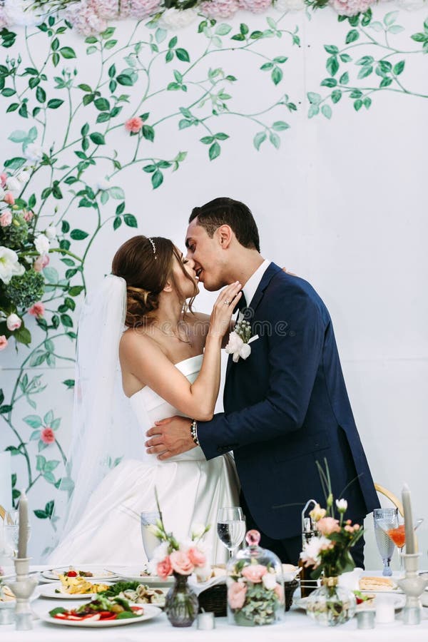 Romantic Kiss of the Married Couple Next To the Table Stock Image ...