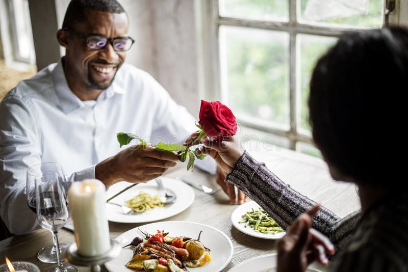 Romantic Man Giving a Rose To Woman on a Date Stock Image - Image of ...