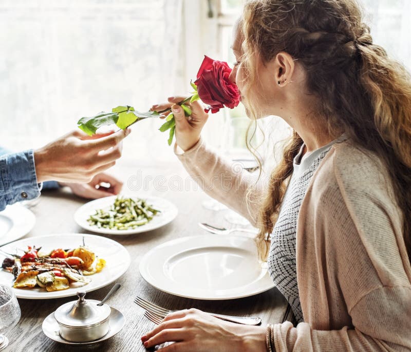 Romantic Man Giving a Rose To Woman on a Date Stock Photo - Image of ...