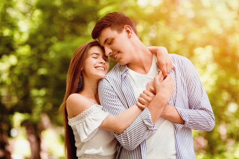 Romantic Millennial Couple Hugging and Feeling Happy in Park Stock ...