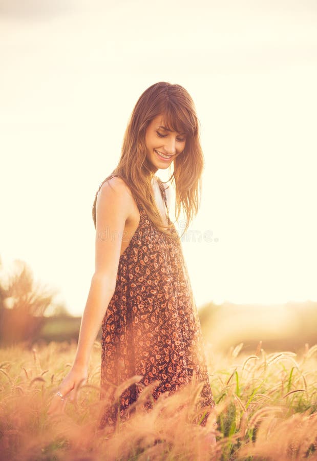 Romantic Model in Sun Dress in Golden Field at Sunset Stock Photo ...