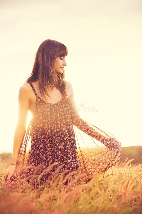 Romantic Model in Sun Dress in Golden Field at Sunset Stock Photo ...